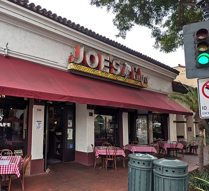 The iconic red awning and vintage neon sign of Joe's Café stand as a time capsule on Santa Barbara's State Street, beckoning hungry patrons since long before Instagram made food famous.