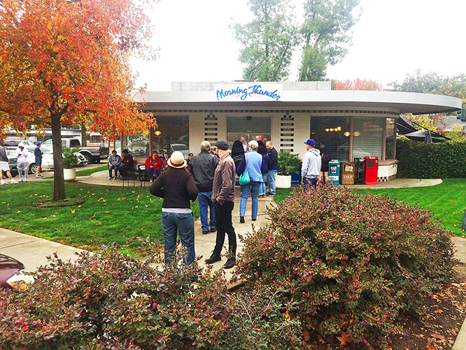 The iconic blue Morning Thunder sign welcomes hungry patrons, who patiently wait outside like pilgrims at a breakfast temple.