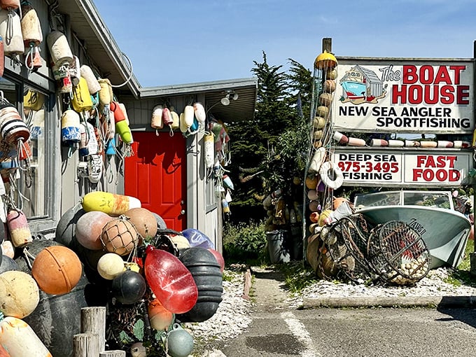 The unassuming exterior of The Boat House, where colorful buoys hang like Christmas ornaments, promising seafood treasures within rather than holiday cheer.