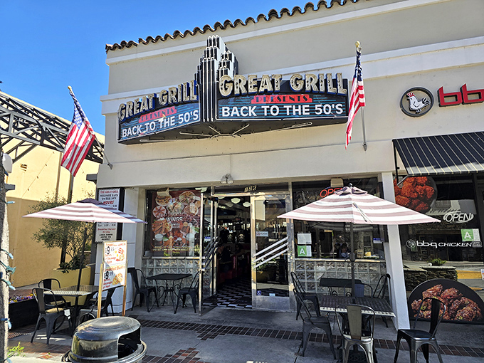 The neon sign beckons like a time portal, American flags standing guard at this Burbank treasure where nostalgia is always on the menu.