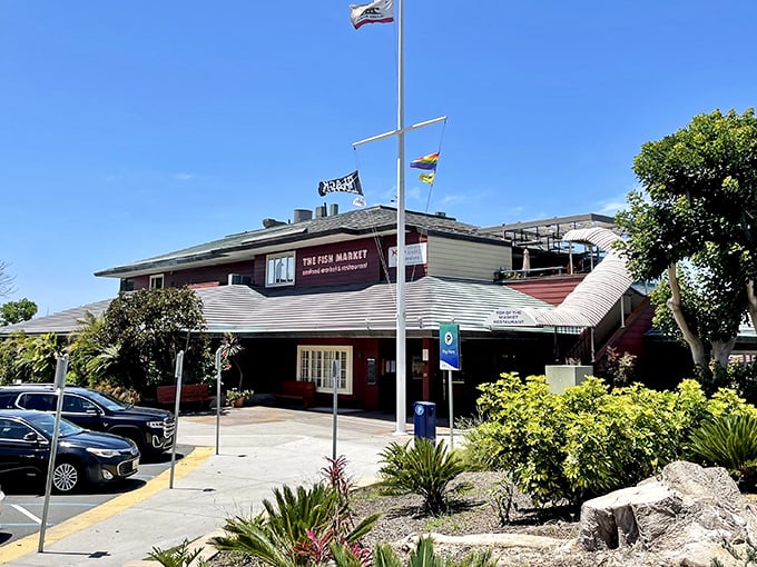 The Fish Market's nautical exterior stands like a welcoming lighthouse for hungry seafood pilgrims. Those flags aren't just for show&mdash;they're signaling "fresh catch ahead!"