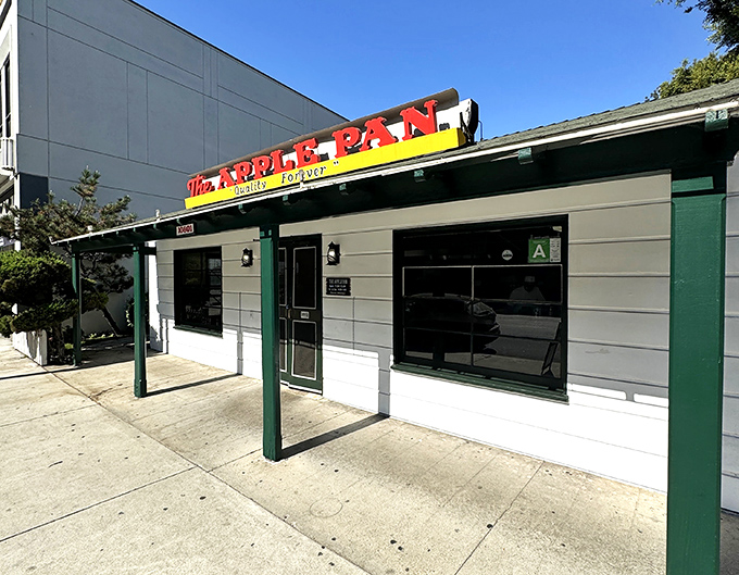 The unassuming exterior of The Apple Pan stands like a time capsule on West Pico Boulevard, its vintage sign promising "Quality Forever" since 1947.