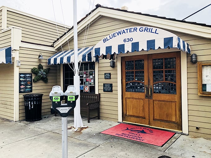 The iconic blue and white awning welcomes seafood lovers like a maritime flag signaling "abandon all diets, ye who enter here."