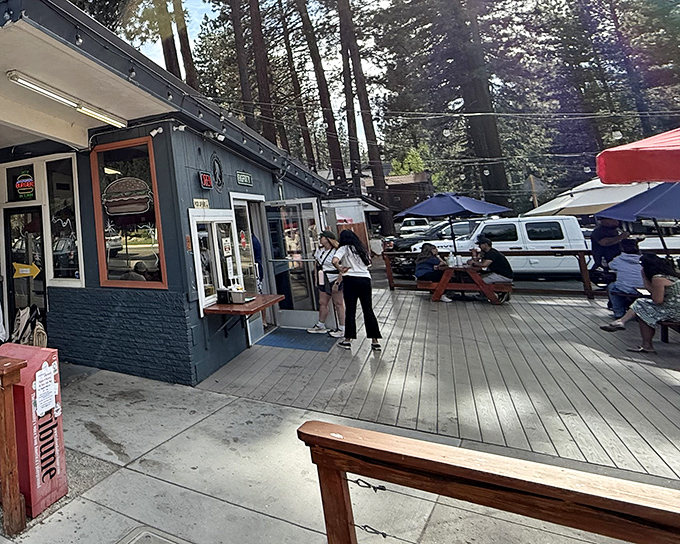 The classic blue exterior of Sno-Flake nestled among towering pines creates that perfect "vacation has officially begun" moment for Tahoe visitors.
