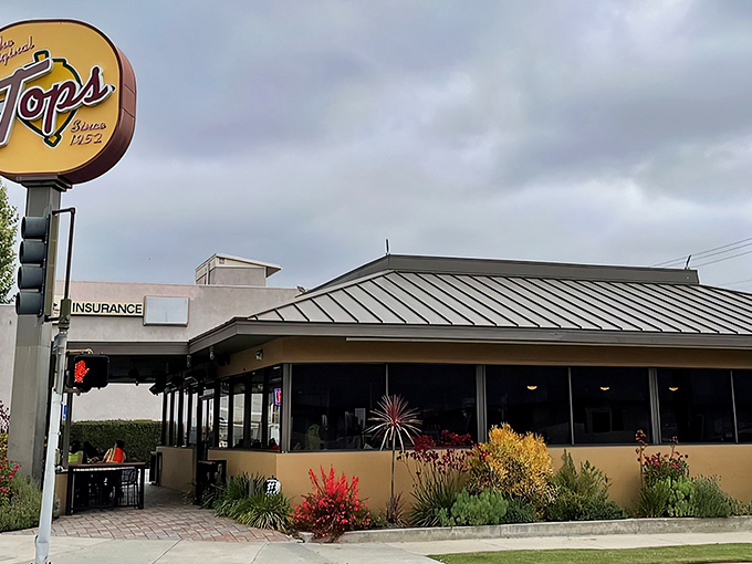 The iconic yellow sign beckons hungry Pasadenans like a burger lighthouse. Some landmarks guide ships; this one guides appetites.