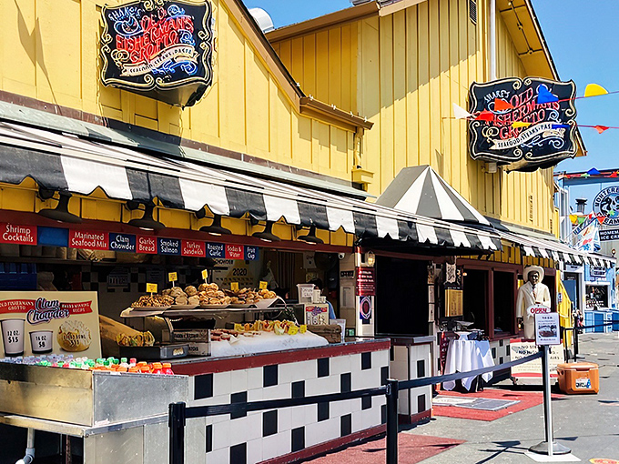 The cheerful yellow exterior with its jaunty black and white awnings stands like a maritime sentinel on Fisherman's Wharf, beckoning hungry travelers with promises of seafood treasures.