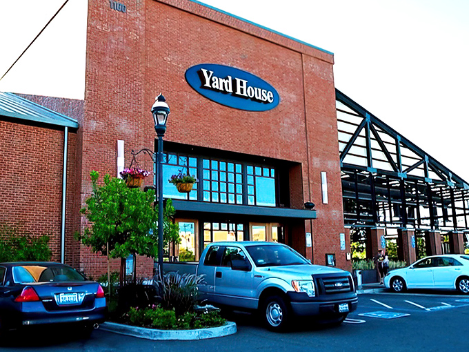 The sleek, modern exterior of Yard House stands like a culinary lighthouse in Fresno, beckoning hungry travelers with promises of craft beer and elevated comfort food.