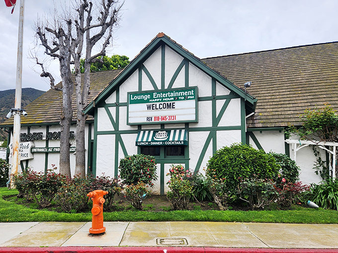 The Tudor-style exterior of The Smoke House stands like a time capsule from Hollywood's golden age, welcoming diners with nostalgic charm.