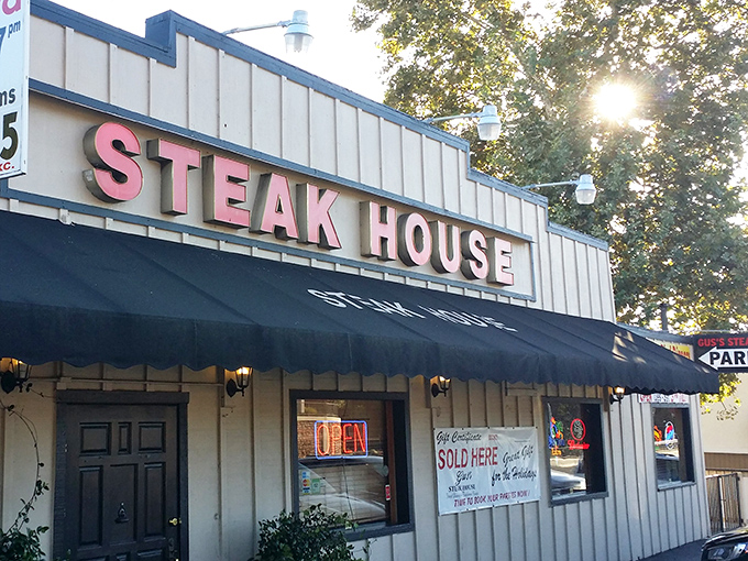 The classic red lettering against cream siding isn't just signage—it's a beacon of hope for hungry travelers. Gus's Steakhouse promises what we all secretly crave: simplicity done spectacularly.
