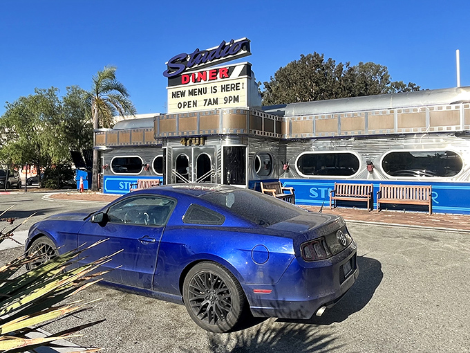The iconic Studio Diner sign stands tall against the San Diego sky, promising cinematic cuisine and happy hour delights in a film-inspired setting.