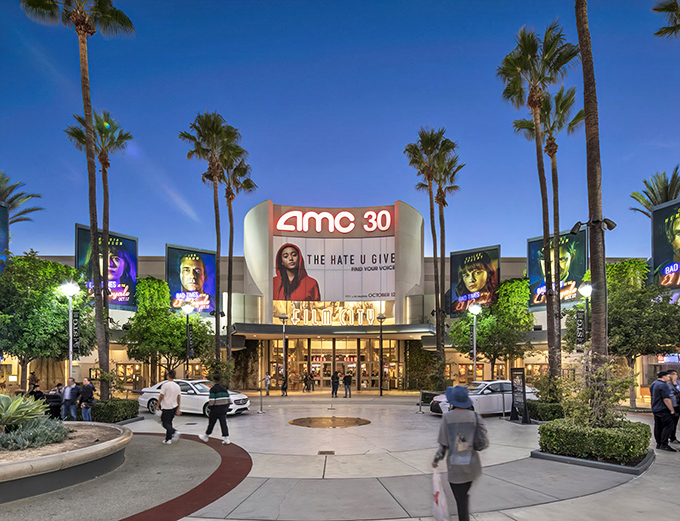 Palm trees frame the AMC 30 like nature's own red carpet, welcoming shoppers to take a cinematic break between bargain hunts.