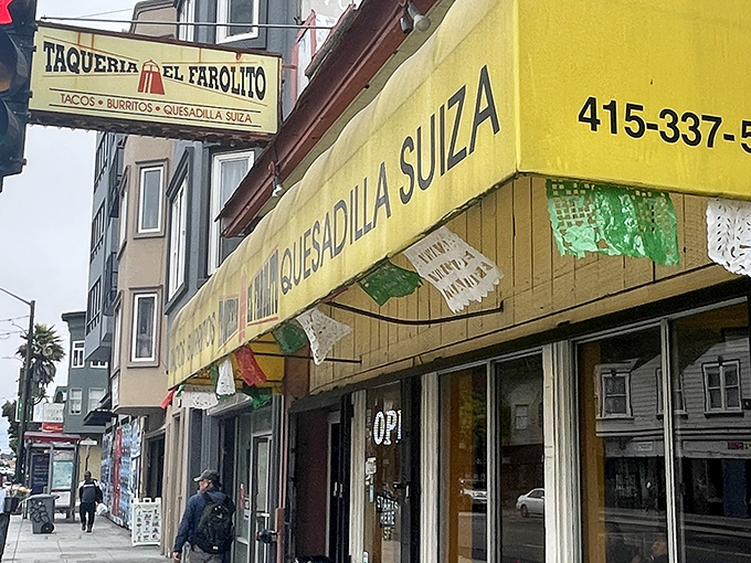 The unassuming yellow storefront of El Farolito stands like a beacon of burrito brilliance on Mission Street, complete with its signature green bicycle sentinel.