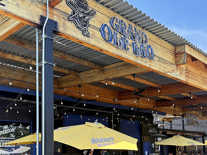 Rustic wooden beams, corrugated metal roofing, and string lights create that perfect "I've discovered something special" vibe at Grand Ole BBQ's inviting exterior.