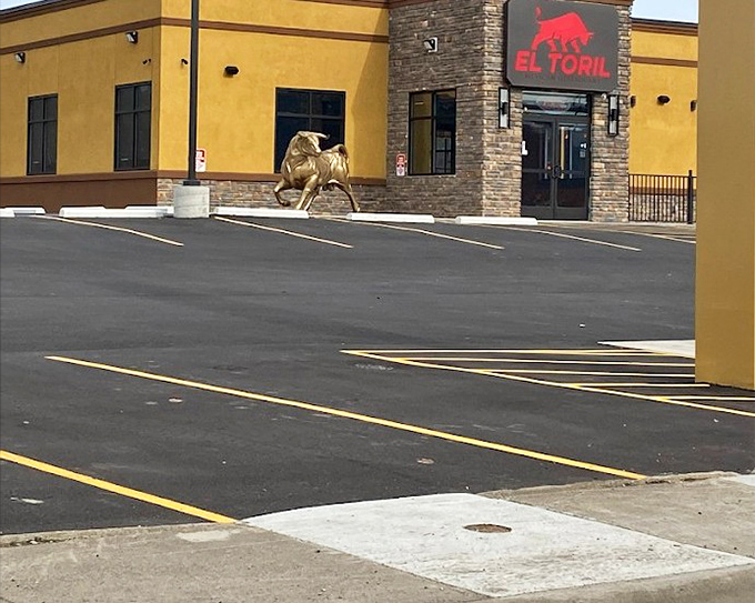 The golden exterior of El Toril stands like a beacon for burrito pilgrims, complete with that iconic red bull signage watching over the parking lot.