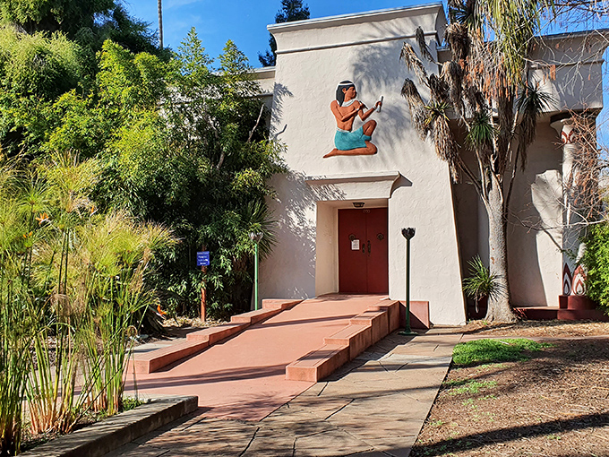 The entrance beckons with ancient Egyptian charm, complete with a seated scribe figure that seems to say, "Come on in, I've been waiting 5,000 years for you!"