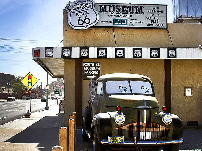 The museum's facade features a vintage green truck with cartoon eyes that seems ready to share tales from its days cruising the Mother Road.