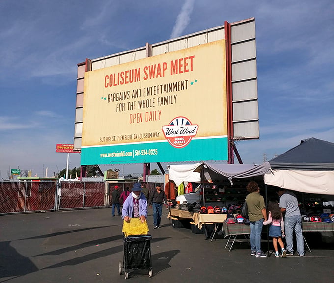 The iconic Coliseum Swap Meet sign welcomes bargain hunters daily, promising treasures and memories for the whole family beneath Oakland's brilliant blue skies.