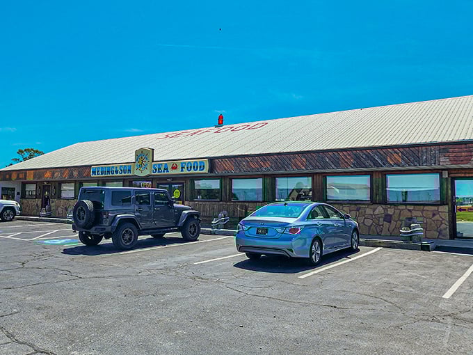 The unassuming exterior of Meding's Seafood beckons like a lighthouse for hungry travelers. That blue sign promises seafood salvation just off the highway. 