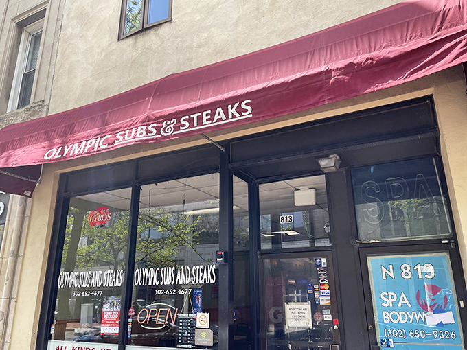 The burgundy awning beckons like a culinary lighthouse on Market Street, promising sandwich salvation to the hungry masses of Wilmington.