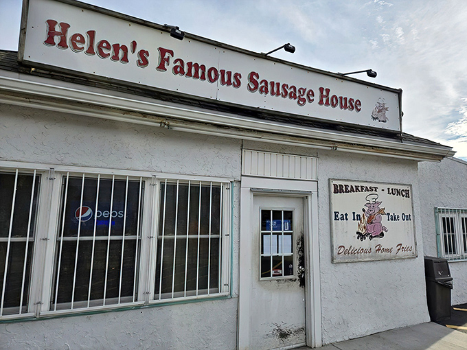 The unassuming white exterior of Helen's Famous Sausage House—proof that culinary greatness doesn't need fancy architecture, just perfect sausage.