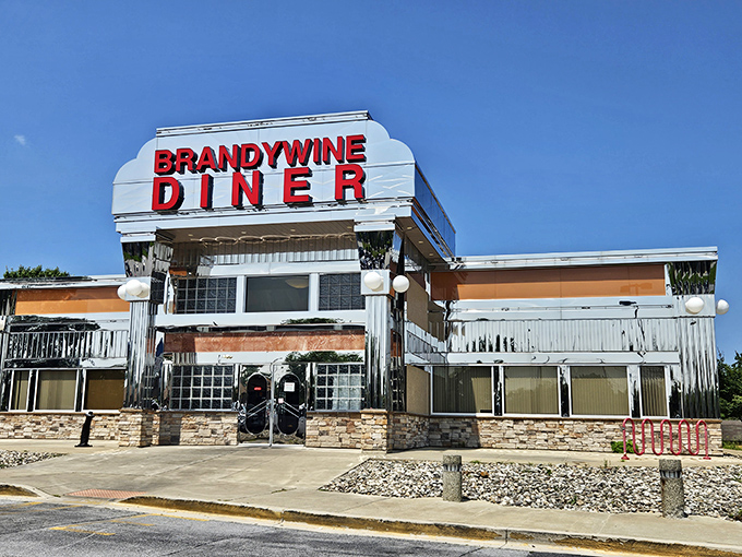 That gleaming chrome exterior isn't just architecture—it's a promise of comfort food nirvana waiting inside. The Brandywine Diner stands proud against the Delaware sky.