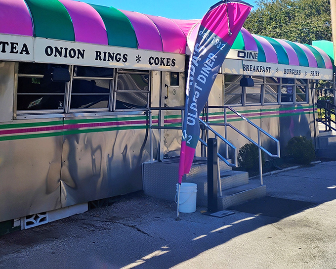 That iconic pink and green awning isn't just eye-catching—it's a beacon of burger perfection that's been drawing hungry Floridians to Palatka since 1932.