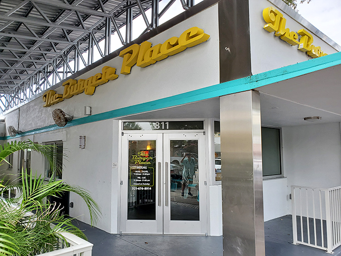 The bright yellow signage of The Burger Place beckons like a culinary lighthouse, promising burger salvation to weary downtown Melbourne wanderers.