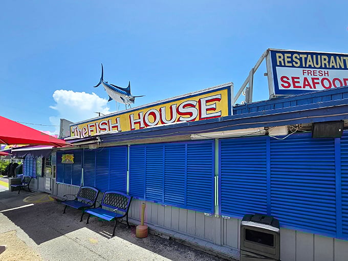 The iconic blue exterior of The Fish House Encore stands proudly in Key Largo, complete with a marlin that seems to say, "Yes, we know our seafood."