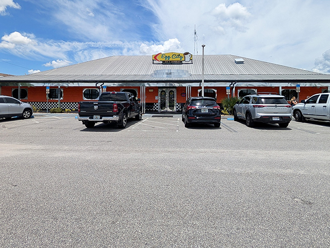 The vibrant orange exterior with classic black-and-white checkerboard trim isn't just eye-catching&mdash;it's practically sending breakfast smoke signals to hungry travelers on the highway.