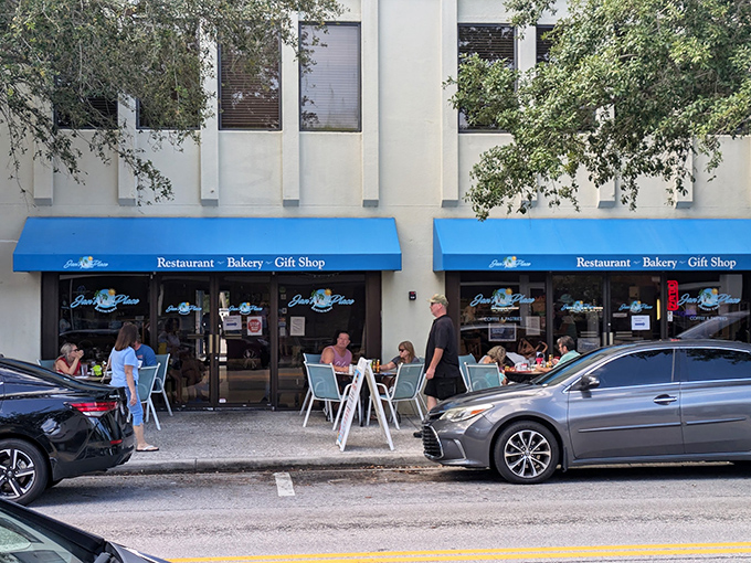 The bright blue awning of Jan's Place beckons like a lighthouse for hungry souls navigating the streets of Jensen Beach.