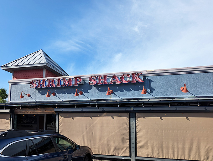 The unassuming exterior of Shrimp Shack belies the seafood treasures within. That simple sign out front? A quiet promise of something crave-worthy inside. 