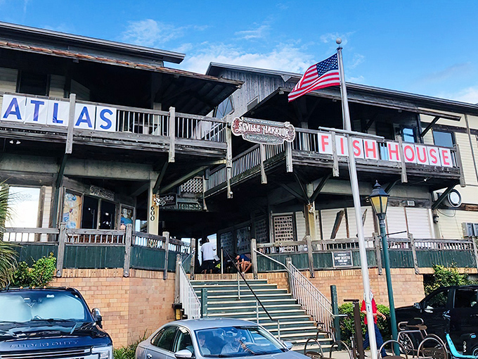 The weathered wooden exterior of The Fish House stands like a sentry over Pensacola Bay, promising seafood treasures within those unassuming walls.