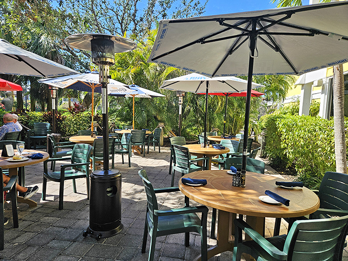 Paradise served al fresco! The outdoor dining area at Lazy Lobster offers umbrella-shaded tables nestled among lush Florida greenery&mdash;perfect for enjoying seafood with a side of sunshine.