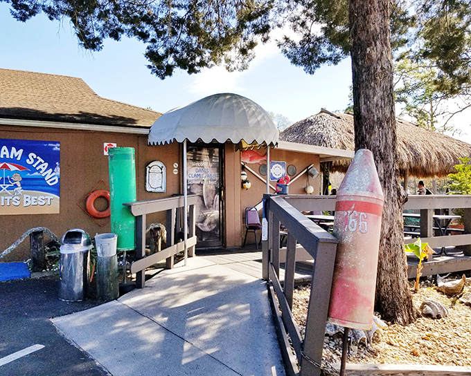 The blue exterior of Dan's Clam Stand with its thatched-roof patio is like finding a secret treasure map to seafood paradise.