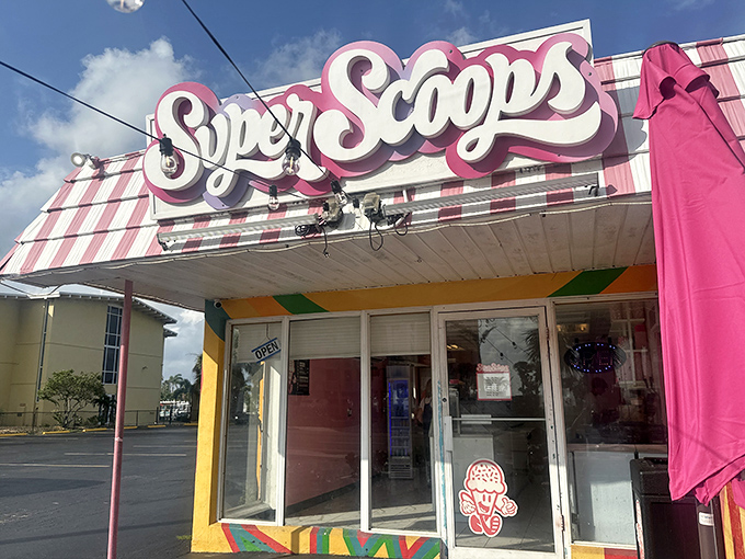 The pink-and-white striped awning of Super Scoops stands out like a beacon of sweetness on Treasure Island, promising frozen salvation from the Florida heat.