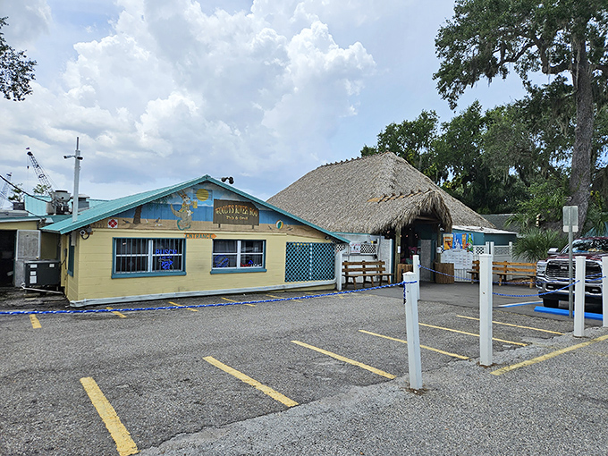 The unassuming yellow exterior of Woody's River Roo might not scream "culinary destination," but that thatched tiki roof whispers "come as you are" with all the charm of Old Florida.