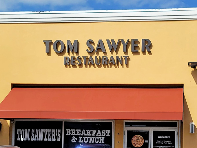The yellow facade with its distinctive red awning stands like a beacon of breakfast hope in Boca Raton. No pretension, just promise.