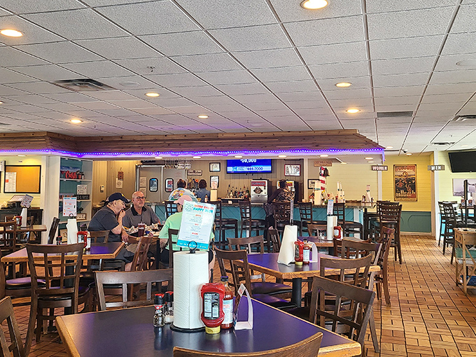 The purple LED lighting adds a touch of unexpected disco flair to this otherwise homey dining room. Classic wooden tables, paper towel rolls, and condiment caddies tell you this place prioritizes flavor over frills.