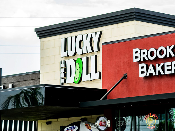 The iconic Lucky Dill sign beckons hungry travelers like a neon-lit lighthouse for sandwich enthusiasts. That green pickle logo? Pure genius.