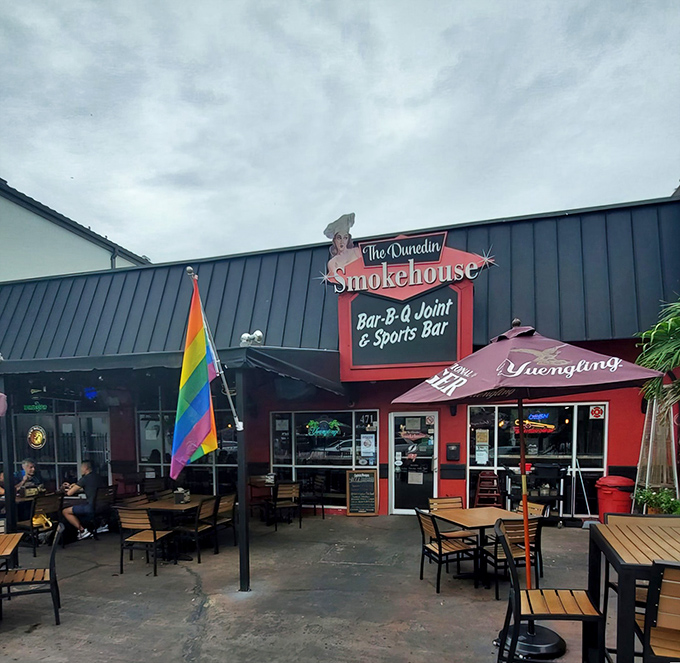 The vibrant red exterior of The Dunedin Smokehouse welcomes hungry visitors with its unpretentious charm. This is where BBQ dreams come true in downtown Dunedin.