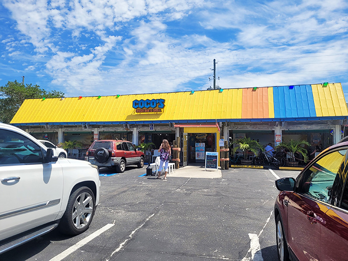The vibrant yellow and blue exterior of Coco's Crush Bar screams "Florida fun" louder than a retiree who just hit the jackpot at bingo night.