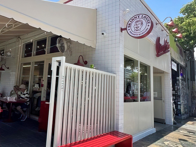 The white-tiled facade with that iconic red script logo is like Miami's version of the Bat-Signal for burger enthusiasts.