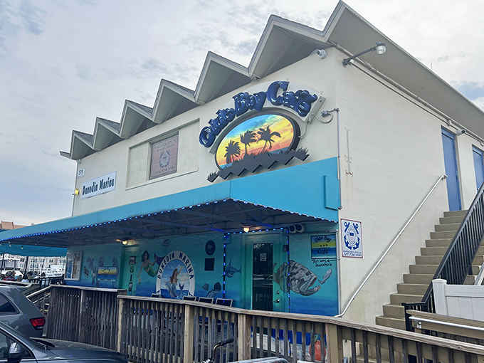 The turquoise facade of Olde Bay Cafe stands out against Florida's sky like a cheerful invitation to seafood paradise. No pretension, just promise.