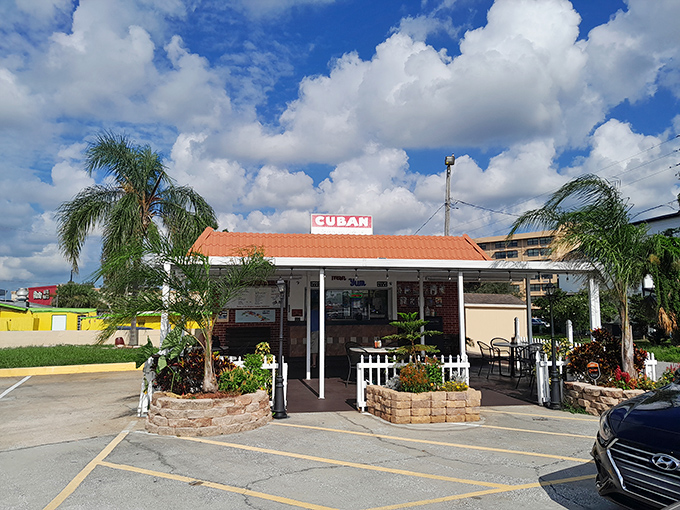 The humble kingdom of Cuban sandwich perfection stands unassumingly under Florida's brilliant blue skies, proving paradise doesn't always require an admission ticket.