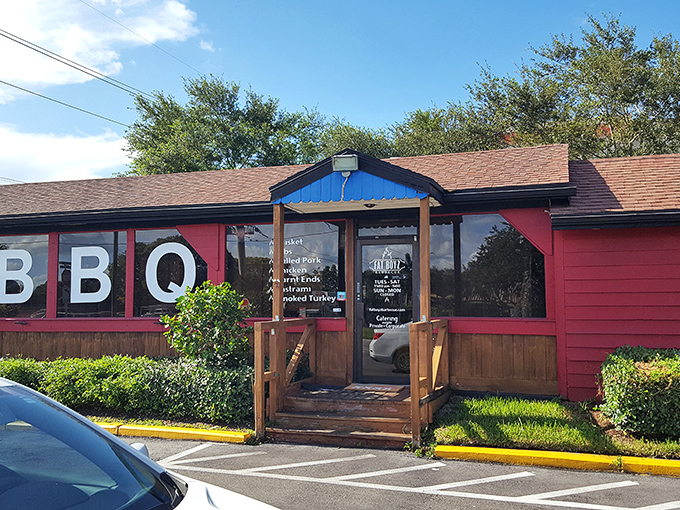 The red building with "BBQ" boldly displayed isn't just announcing its presence&mdash;it's making a solemn promise your taste buds won't soon forget.