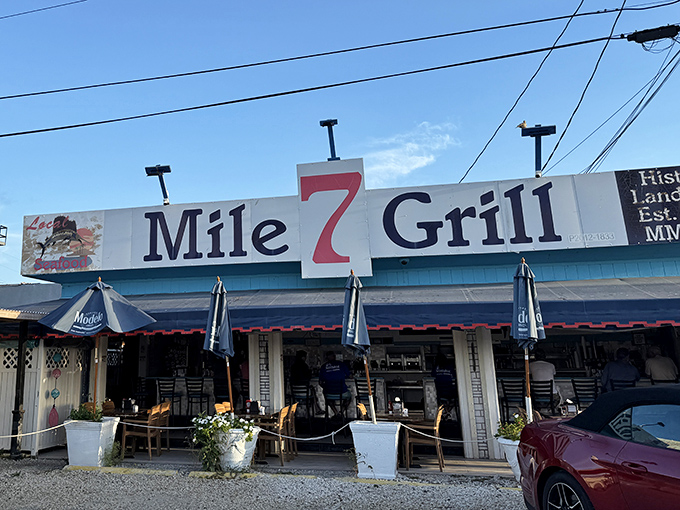 The iconic blue and white facade of Mile 7 Grill stands proudly along the Overseas Highway, a beacon for hungry travelers and locals alike.