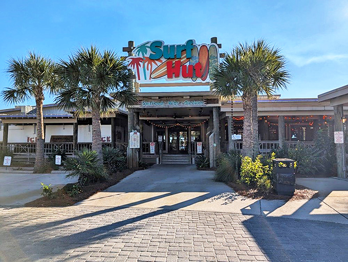 The iconic Surf Hut sign welcomes beach-goers with its vibrant colors and laid-back vibe&mdash;like a friendly wave from an old friend.