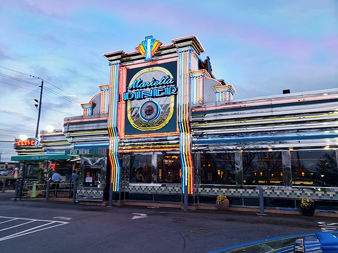 The neon-drenched facade of Marietta Diner glows like a beacon of comfort food hope on Cobb Parkway, promising delicious salvation 24 hours a day.