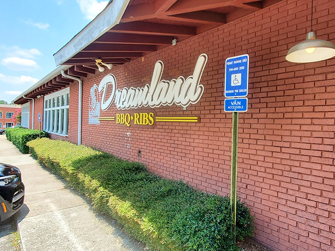 The brick exterior of Dreamland BBQ promises no-frills authenticity. Like a BBQ time machine, this unassuming building houses smoky treasures waiting to be discovered.