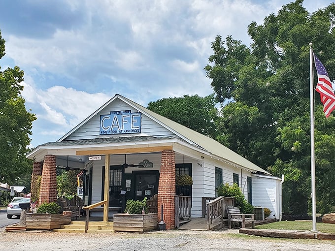 The unassuming white clapboard exterior of The Whistle Stop Cafe stands as a time capsule of Southern charm, promising culinary treasures within.